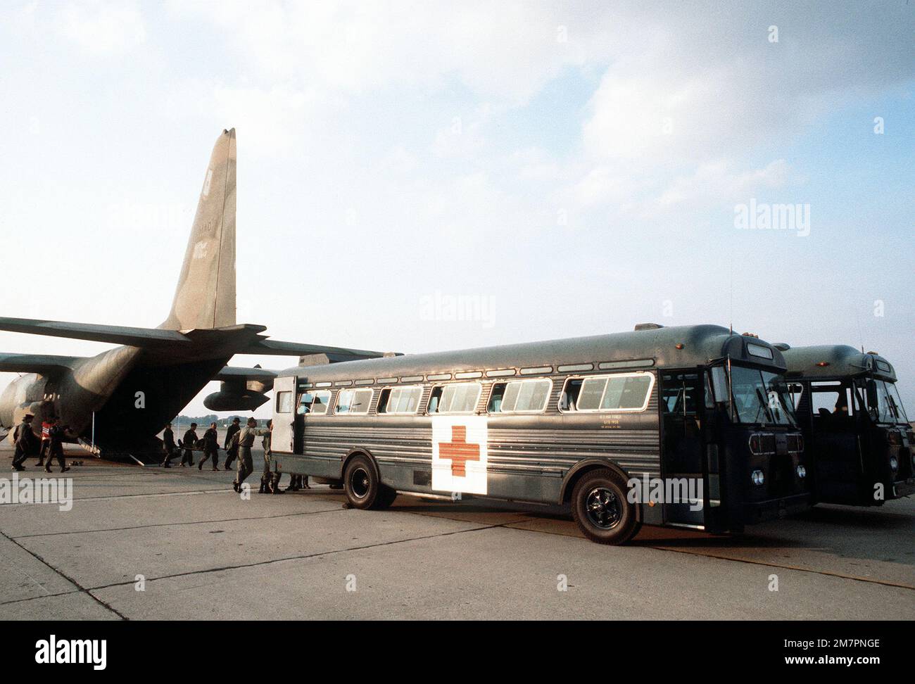 Patients are transferred from a C-130 Hercules aircraft to medical ...