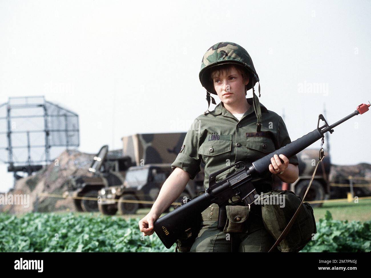 AN airman first class with an M-16 rifle guards the camouflaged forward ...