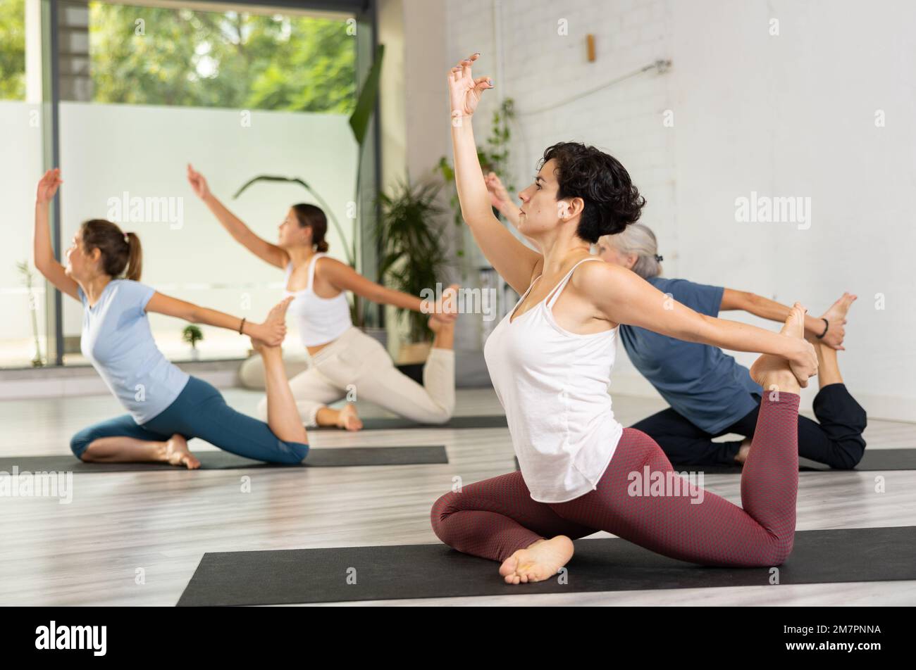 Happy young girl and group of active beautiful multinational women ...