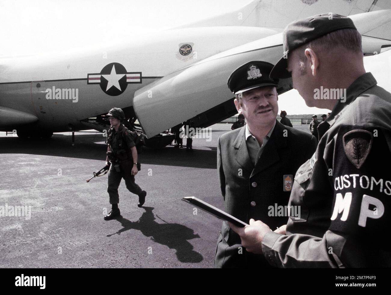 CPT Howard Jacobi, a military policeman, discusses the unloading of ...