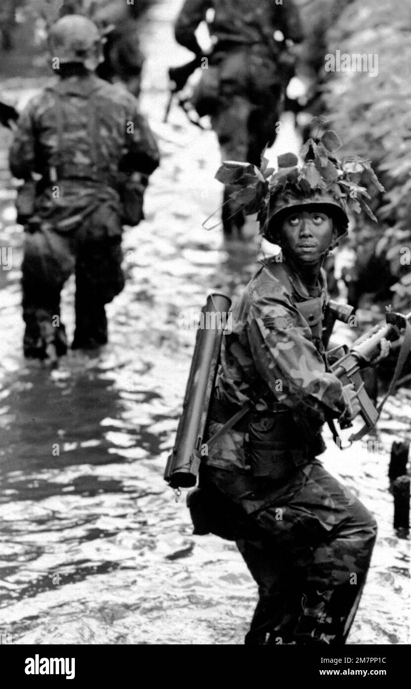 A1C Francis N. Aronce, 60th Security Police Squadron, covers a four-man ...