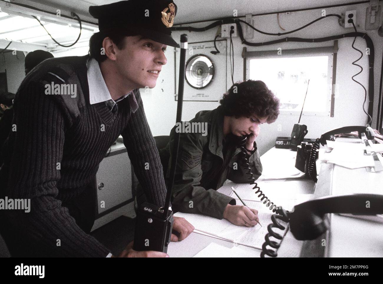 LT. Jan Six and SGT Kim May, left to right, coordinate the arrival of ...