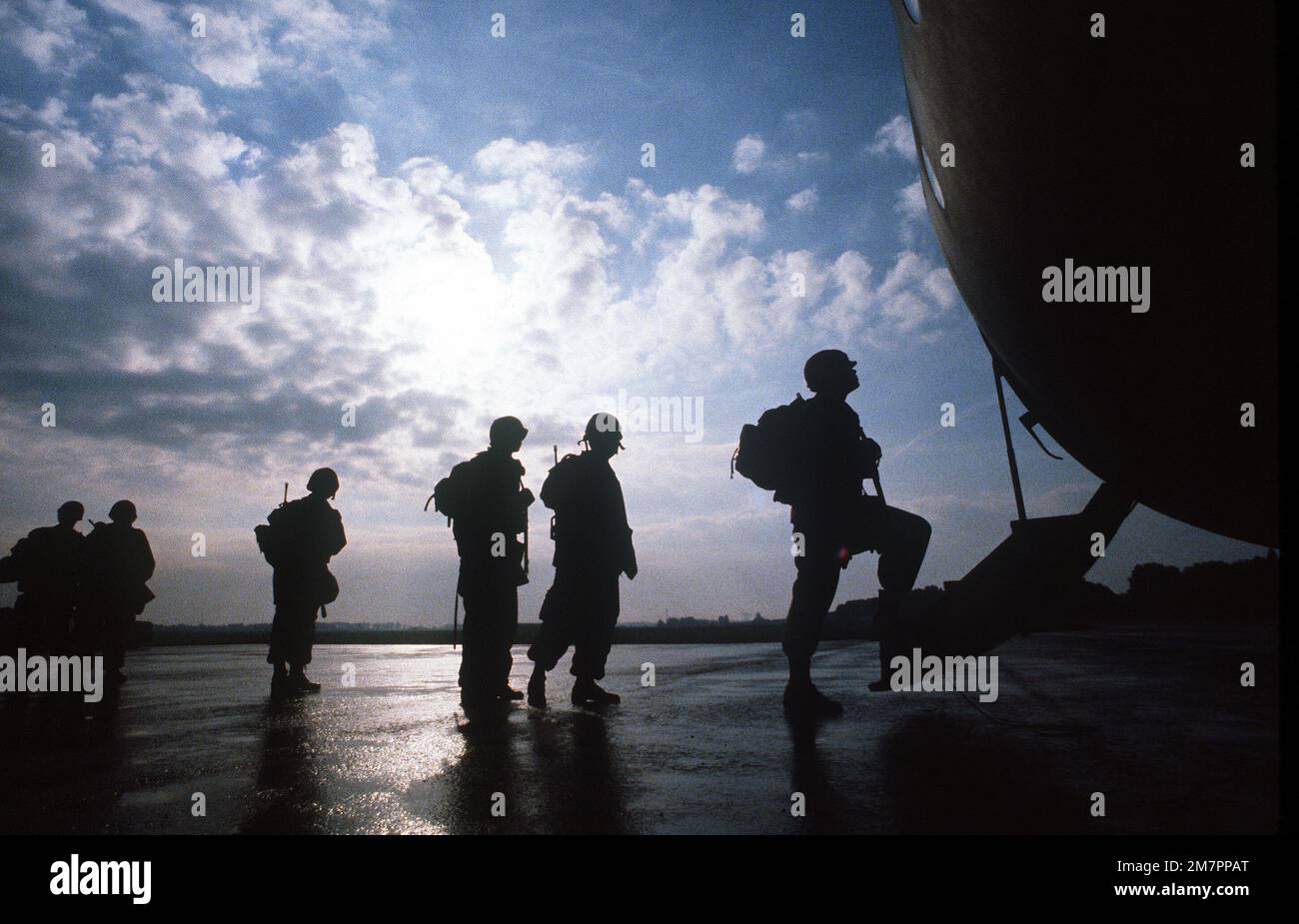 Silhouette view of members of the 16th Signal Battalion embarking on a ...