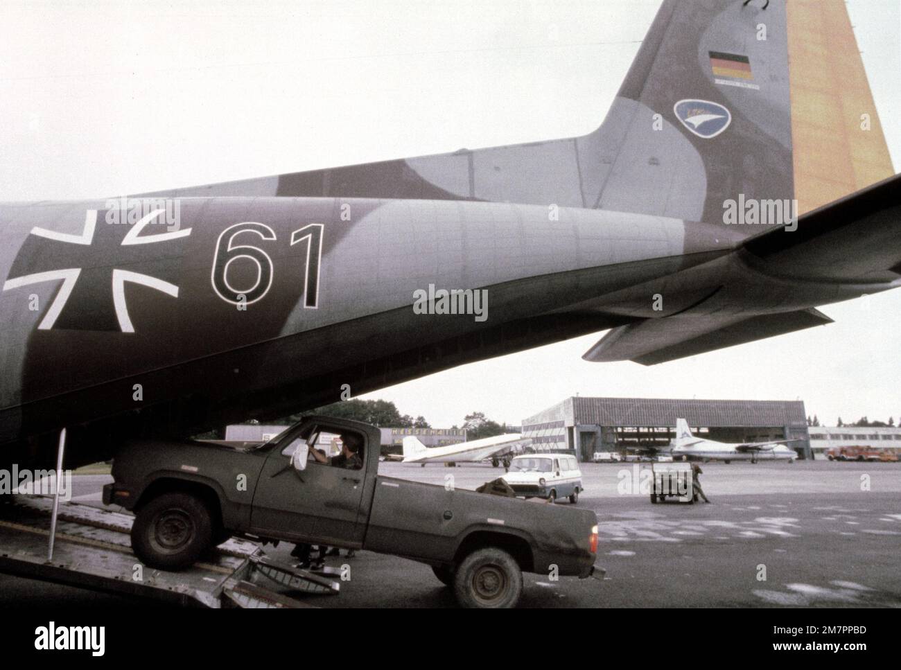 An airman drives a truck aboard a German Air Force C-160 aircraft ...