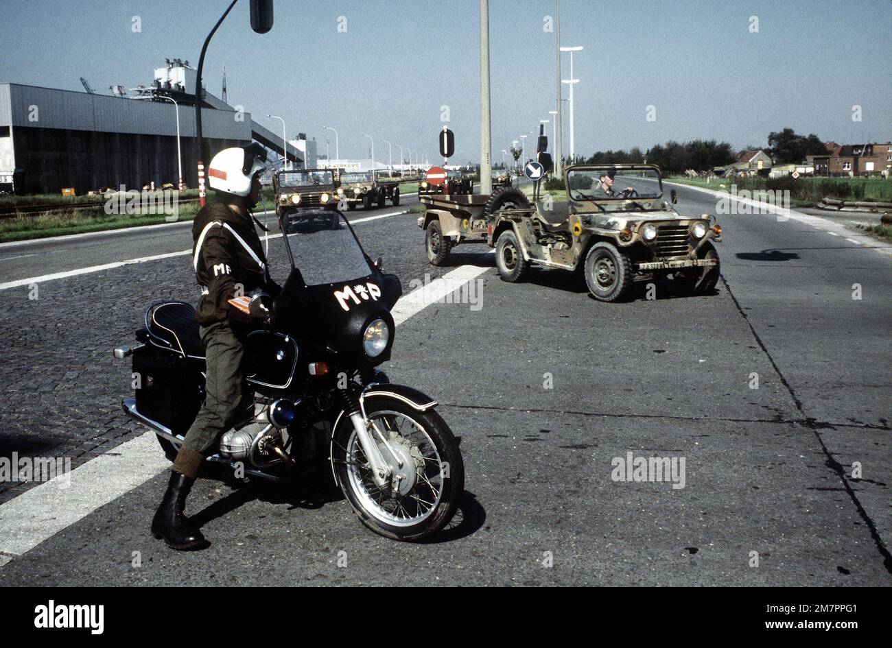 A convoy of Army vehicles leaves the pier during exercise Reforger '80 ...