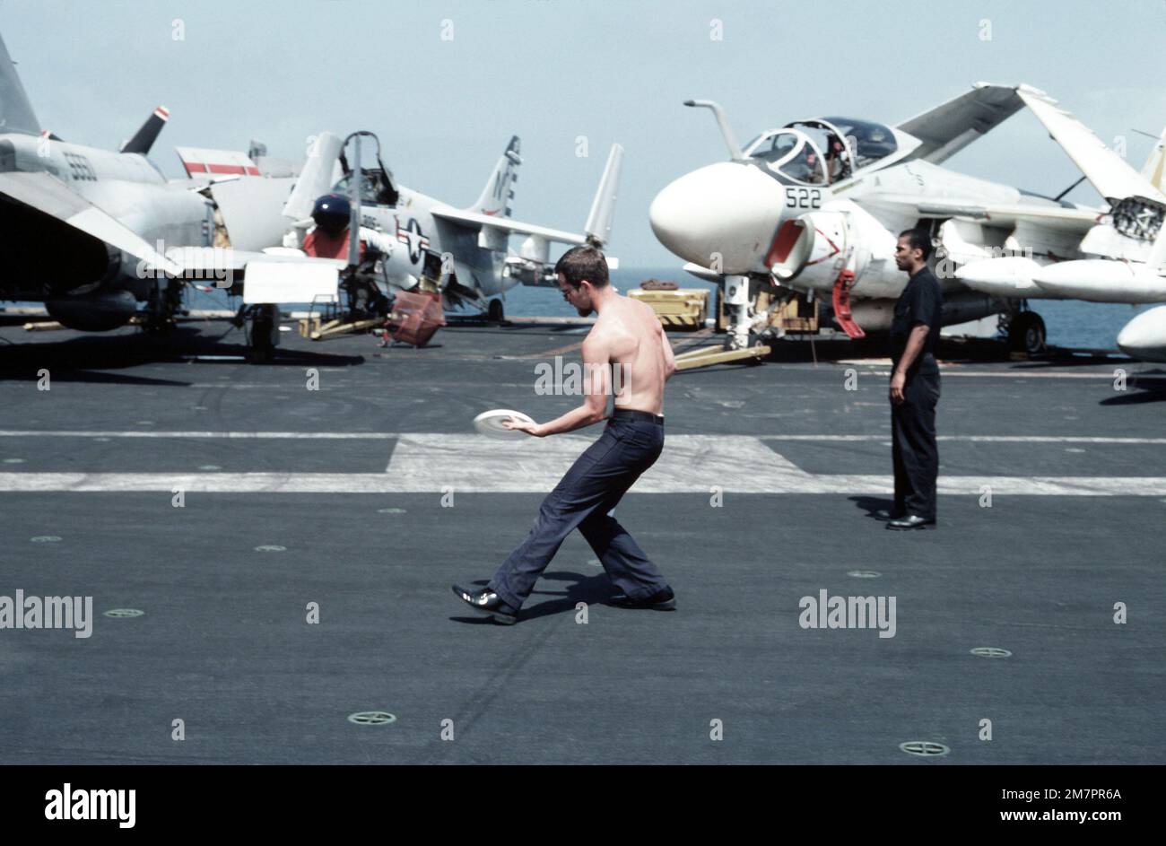Crewmen aboard the aircraft carrier USS MIDWAY (CV 41) play a game of ...