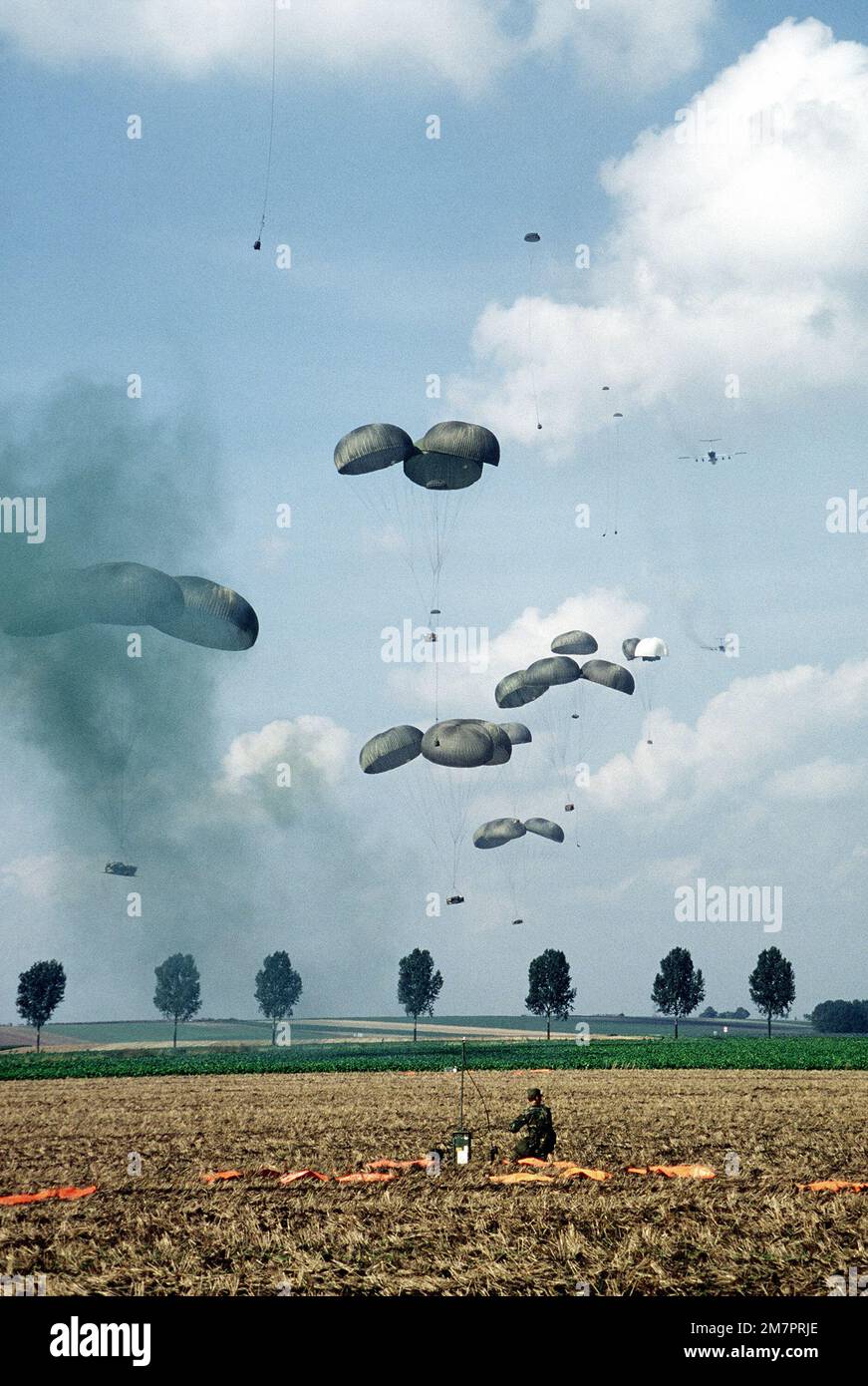 C-141B Starlifter aircraft airdrop cargo during exercise Reforger '80 ...