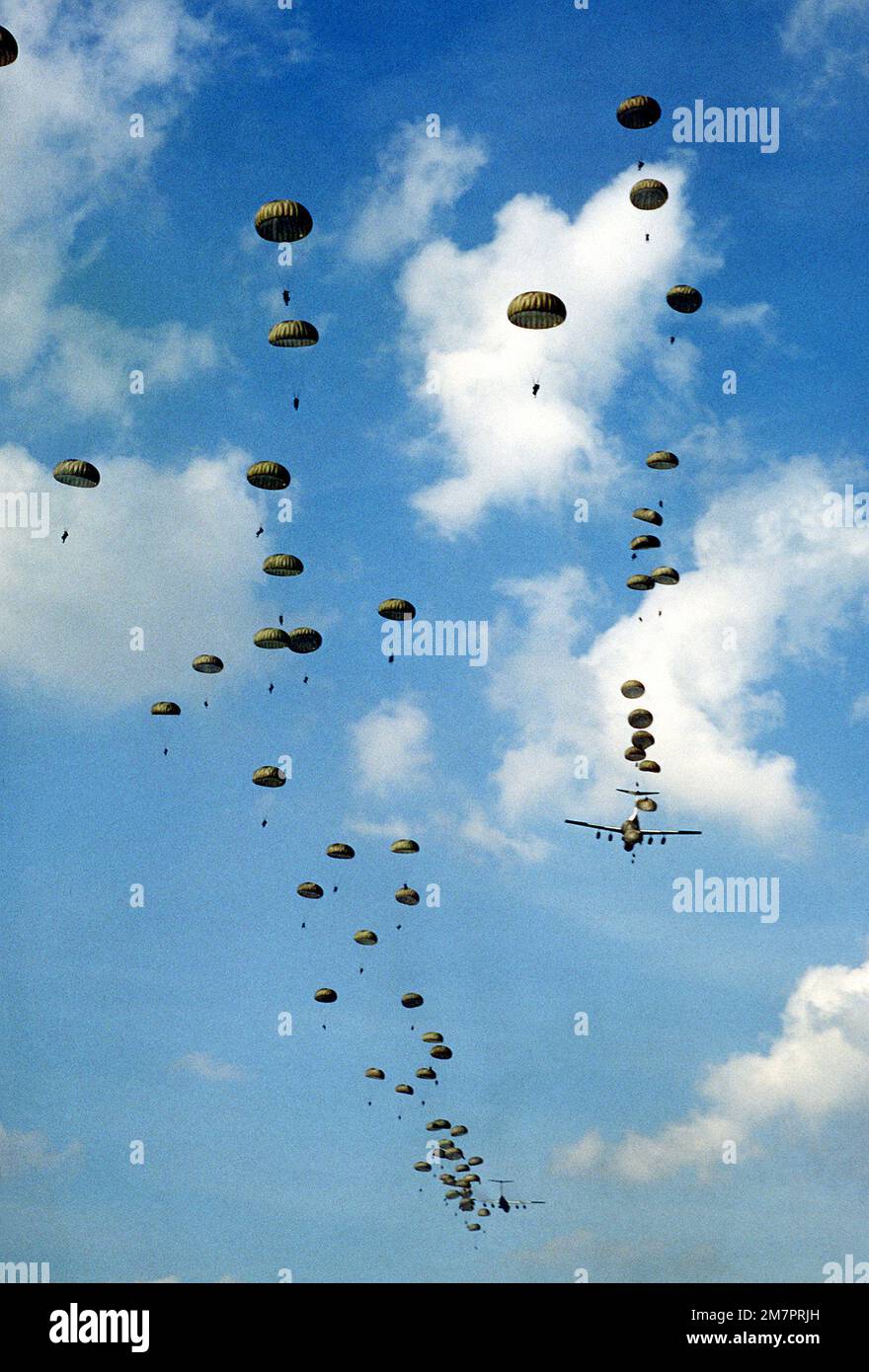 Members of the 82nd Airborne Division parachute from a C-141B ...