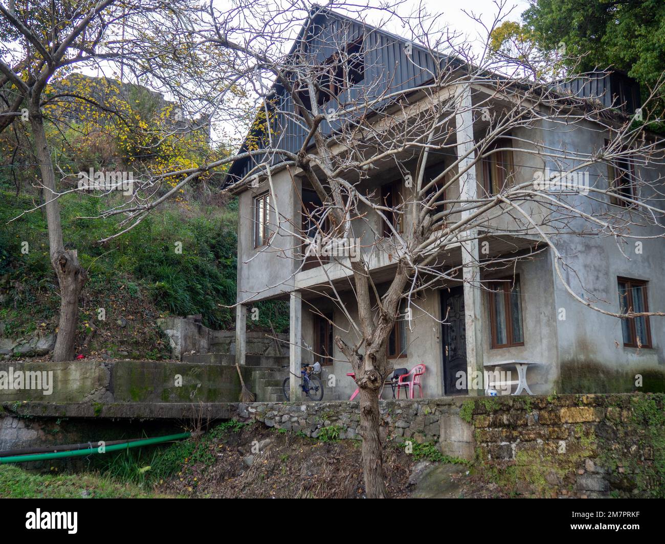 Old gray house. Manor made of concrete. Unfinished cottage. Scary house ...