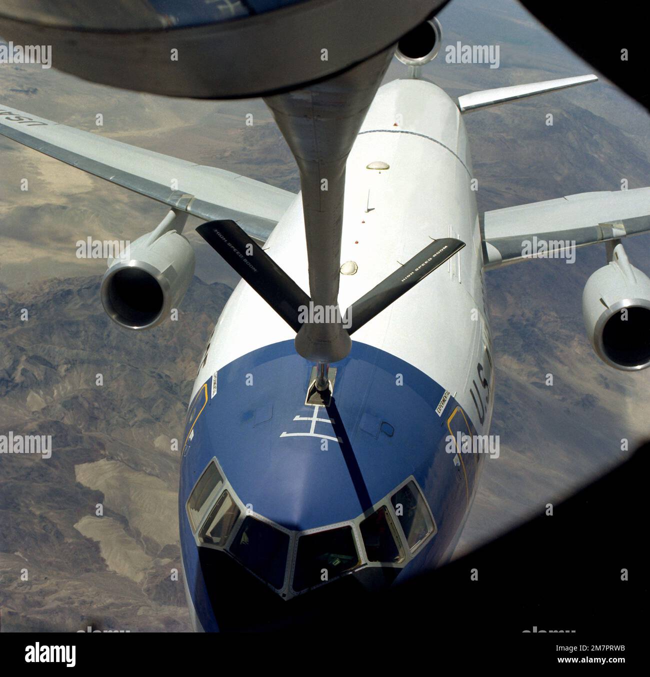 AN air-to-air overhead view of a KC-10 Extender aircraft being refueled ...