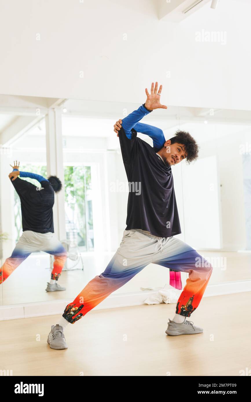 Vertical image of biracial male hip hop dancer practicing at dance ...