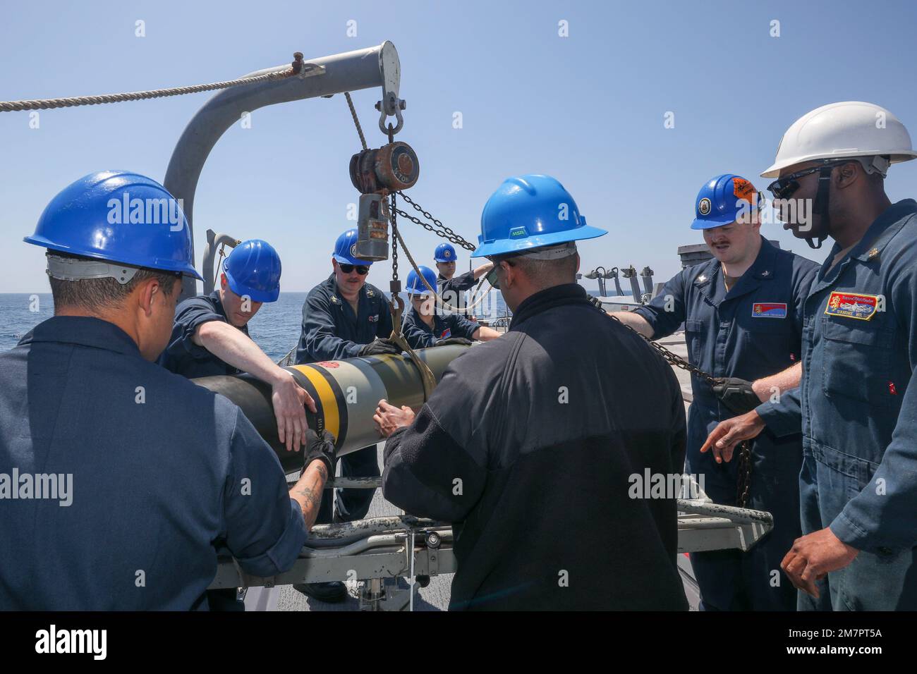 PHILIPPINE SEA (May 11, 2022) Sailors load a torpedo on the fantail of ...