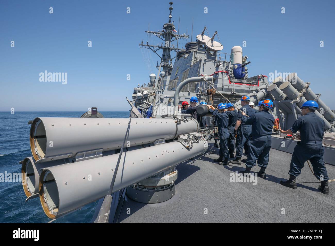 PHILIPPINE SEA (May 11, 2022) Sailors load a torpedo on the fantail of ...