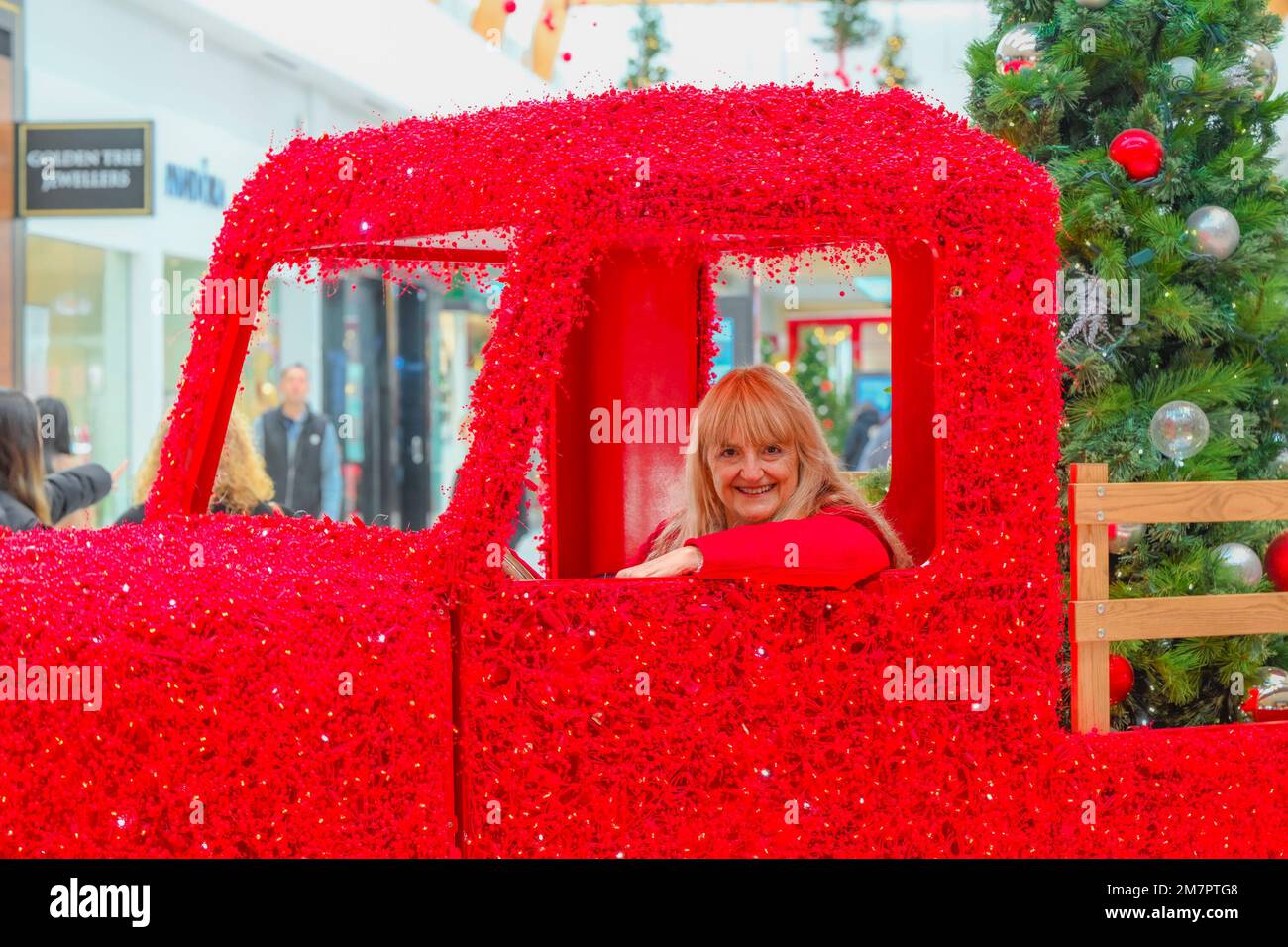 Blonde woman in Red Pickup Truck, Christmas art installation ...