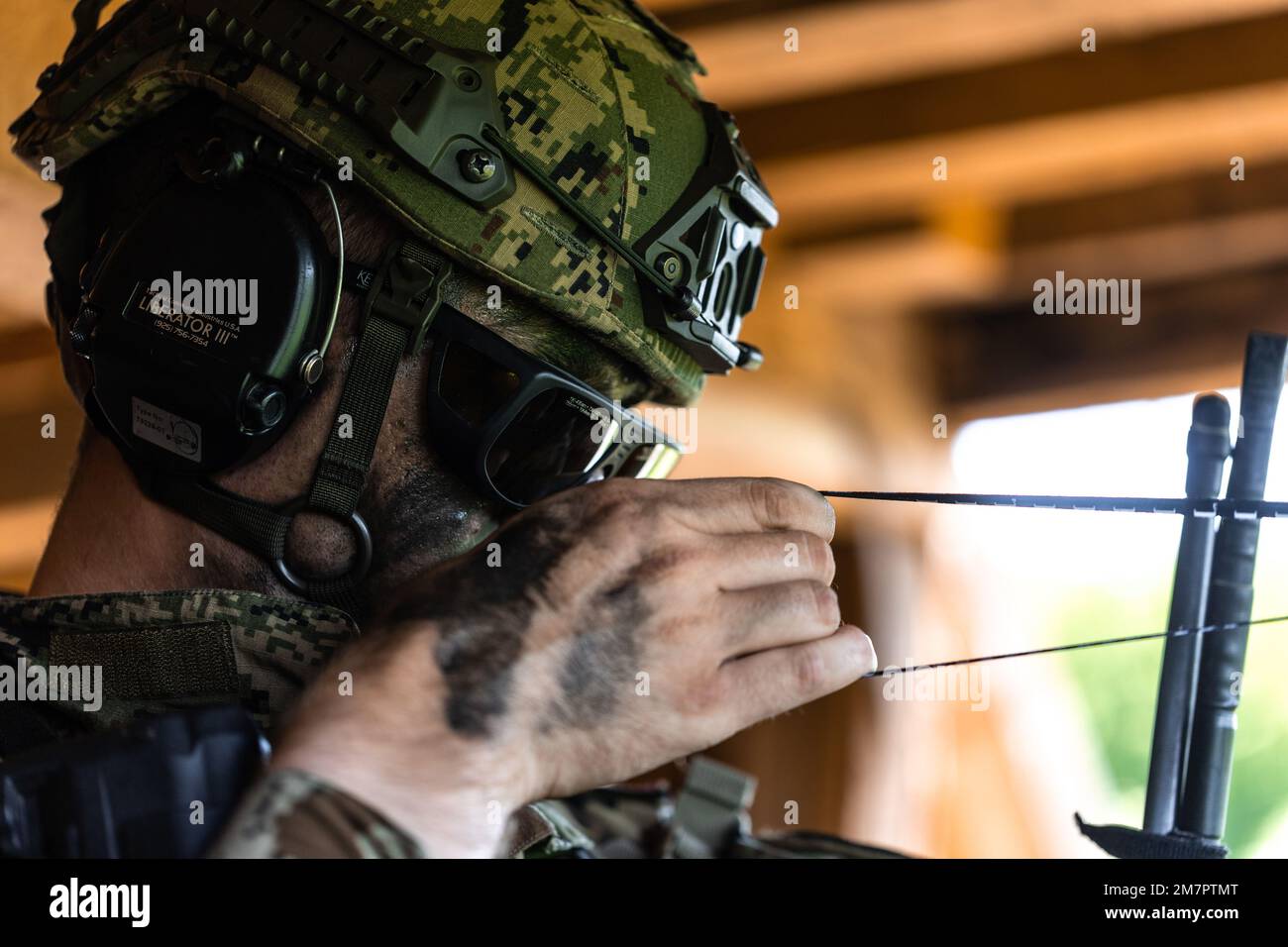 A Croatian Army Special Forces Joint Terminal Attack Controller (JTAC) checks his compass ...