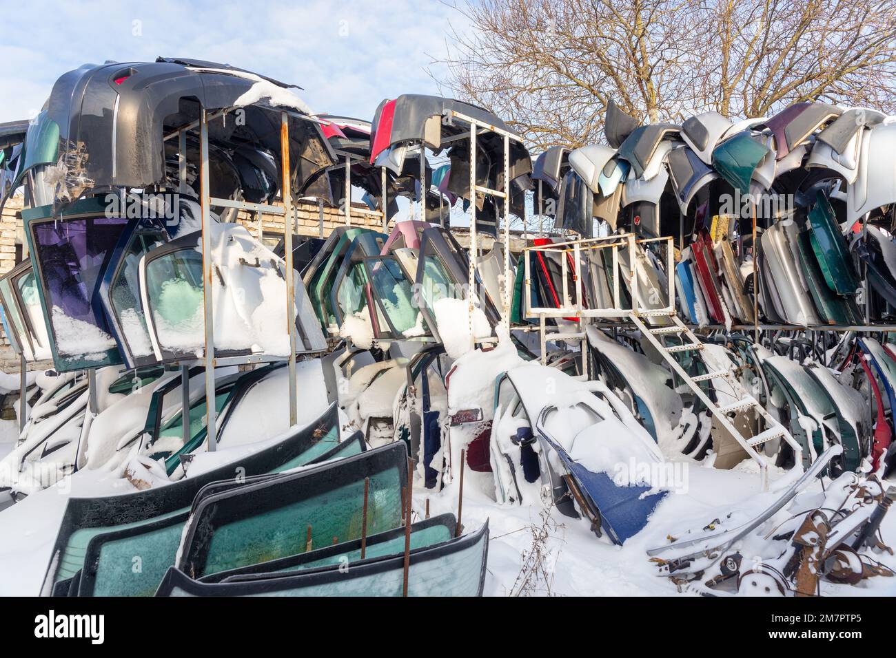 Disassembled cars on a car dump are on sale for spare parts. A stack of ...