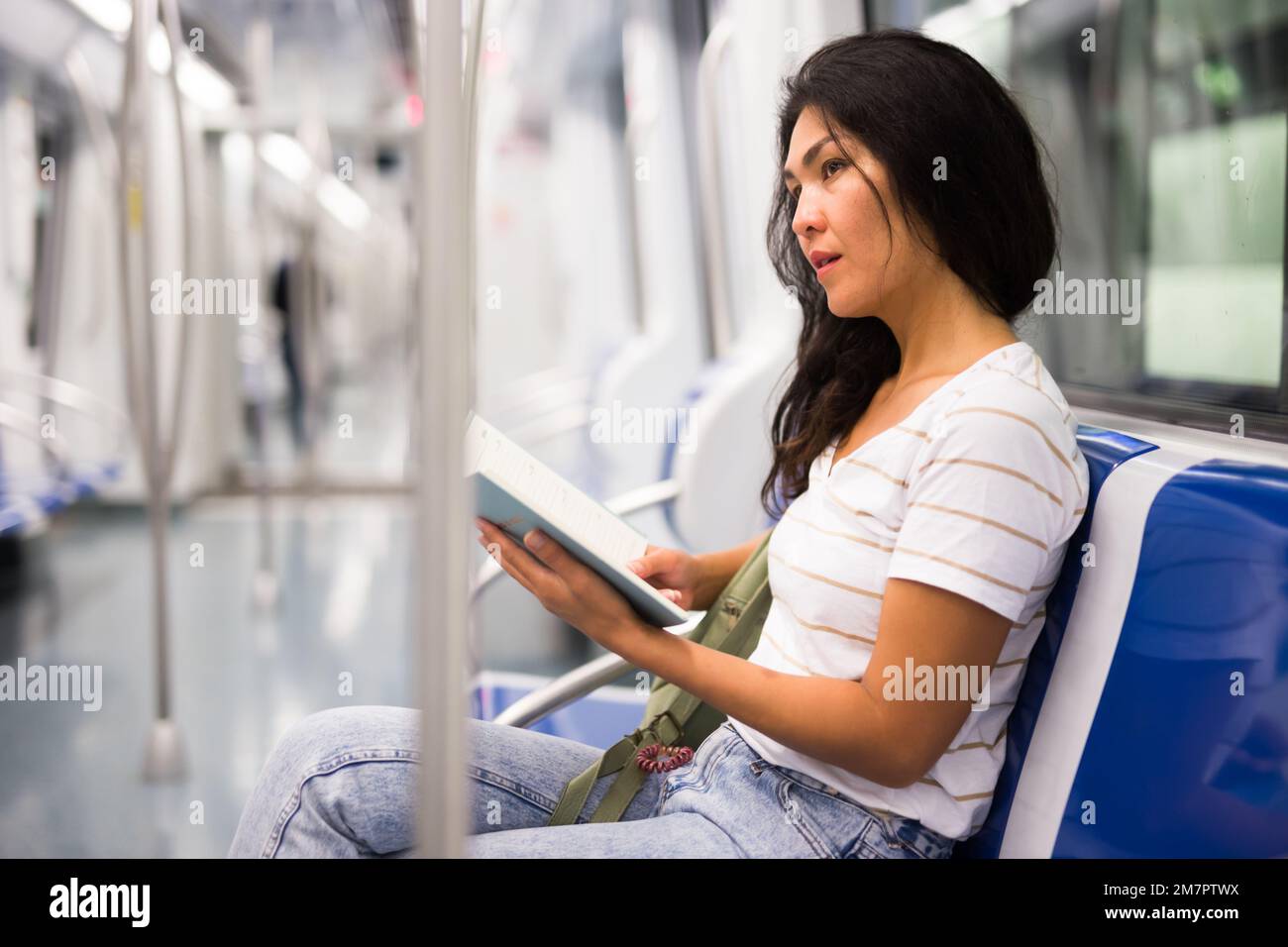 Asian woman reading book train hi-res stock photography and images - Alamy