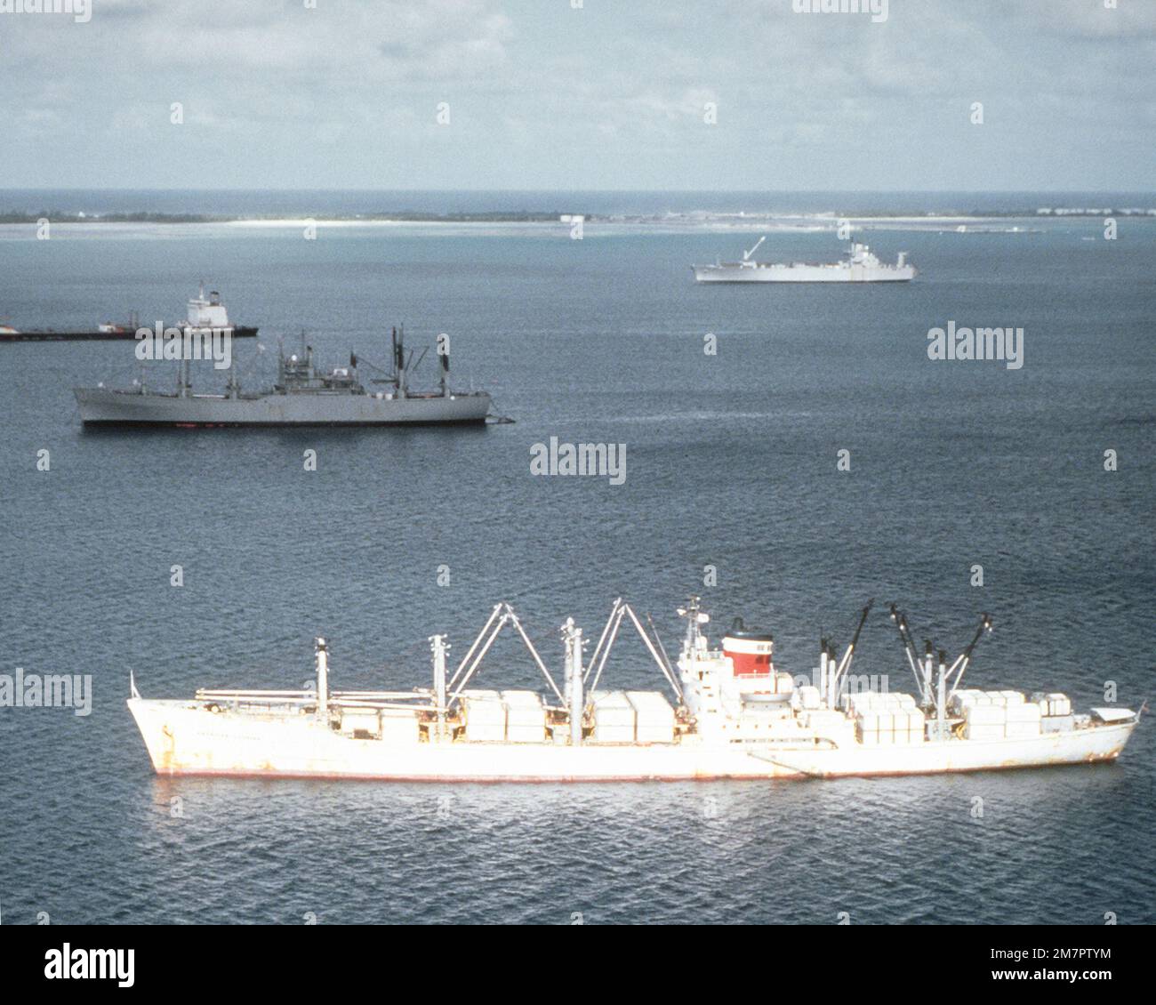 A port beam view of the cargo ship AMERICAN COURIER (T-AK-0107) at ...