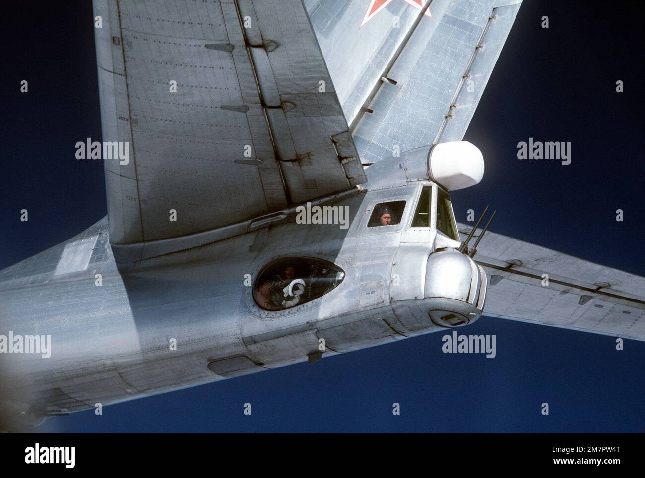 AN air-to-air left side view of the tail section of a Soviet Tu-95 Bear ...