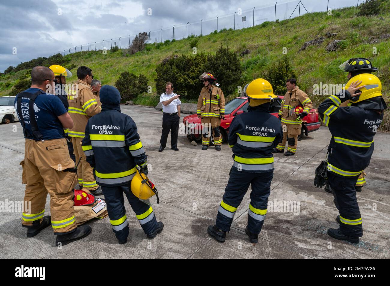 Firefighters assigned to the 65th Air Base Squadron brief Portuguese ...
