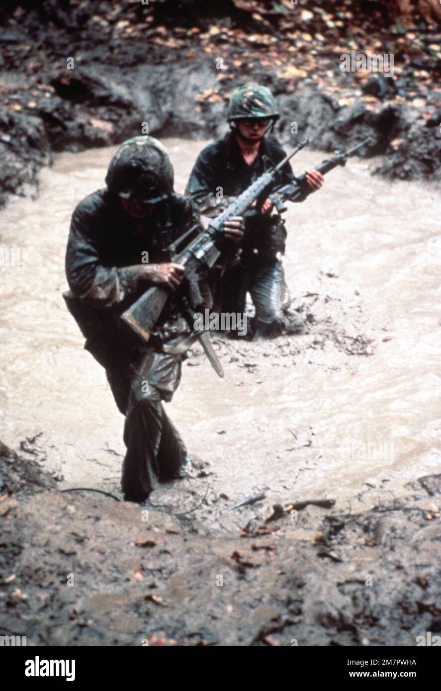 Two Marine officer candidates from The Basic School, move through a ...