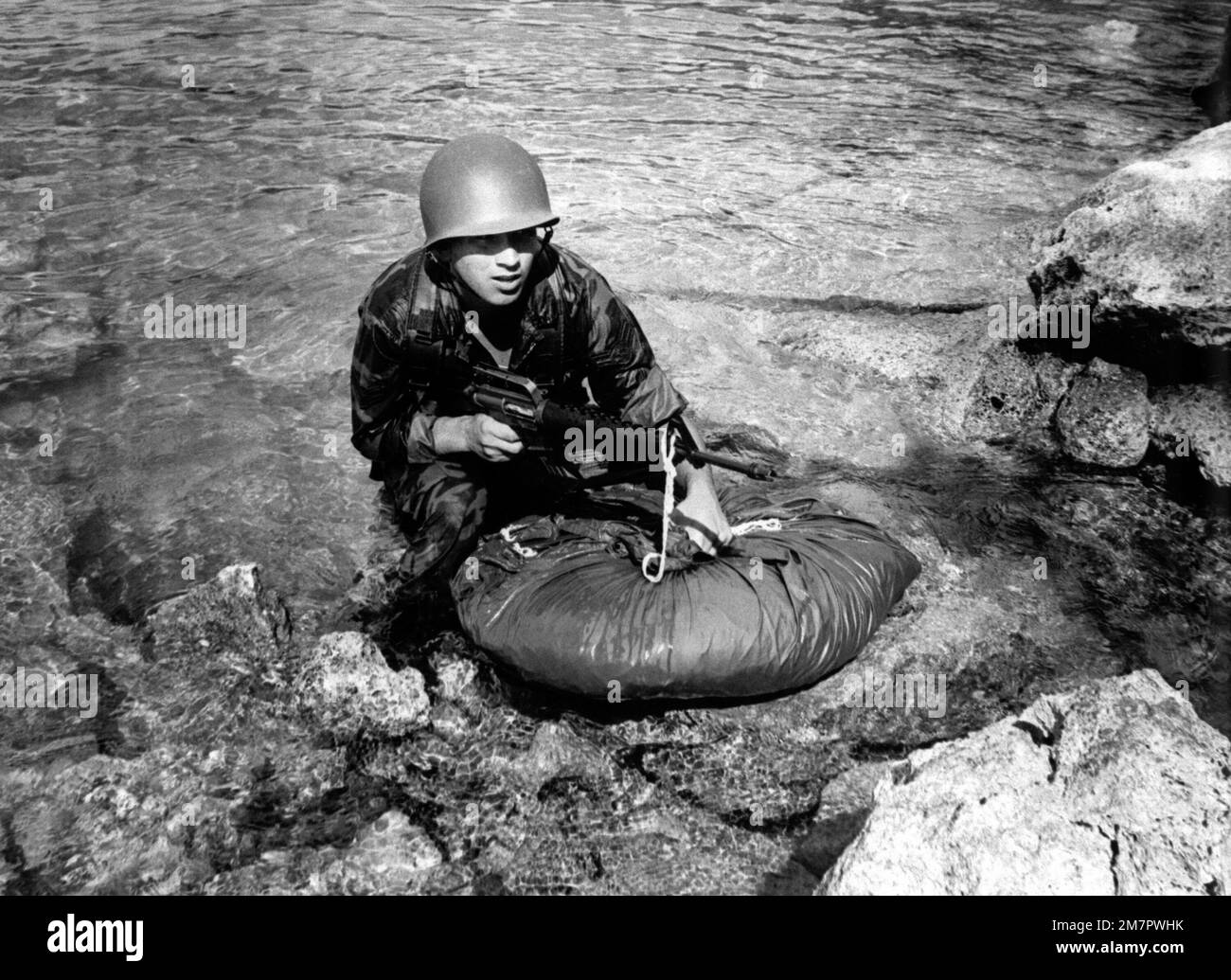 A1C Robert Jeffery makes a beach landing in a raft made from his poncho ...