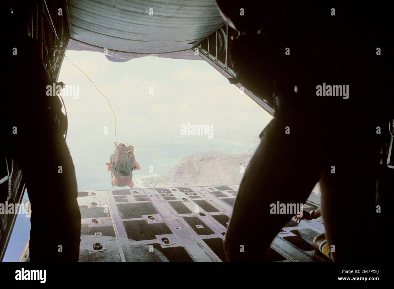A combat control team member makes a static line jump from an aircraft ...