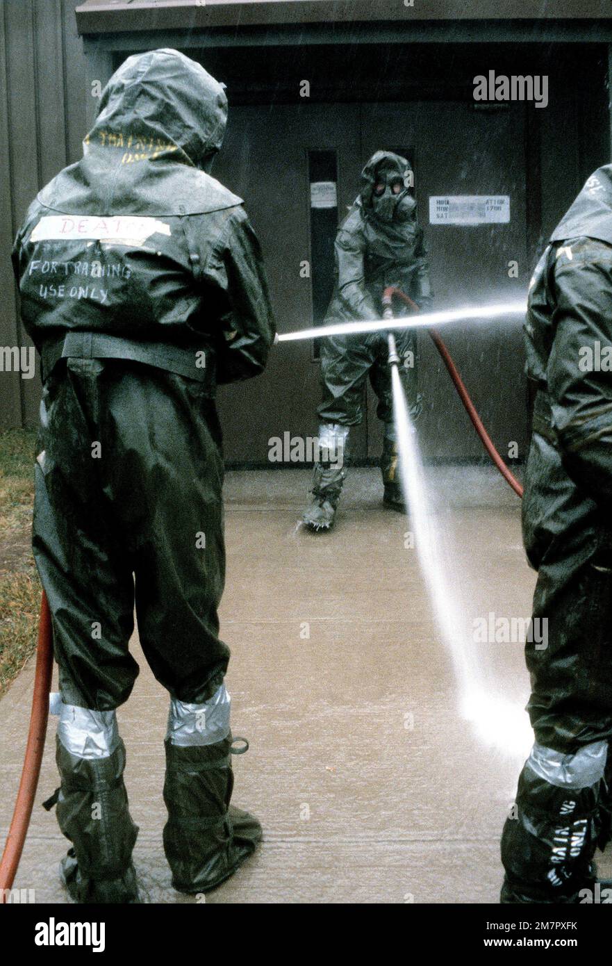 Dressed in chemical warfare gear, Disaster Preparedness personnel ...