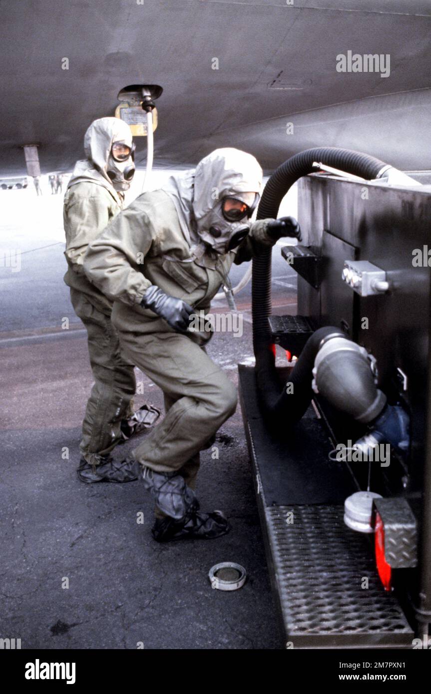 Crew members of the 436th Military Airlift Wing, dressed in chemical ...