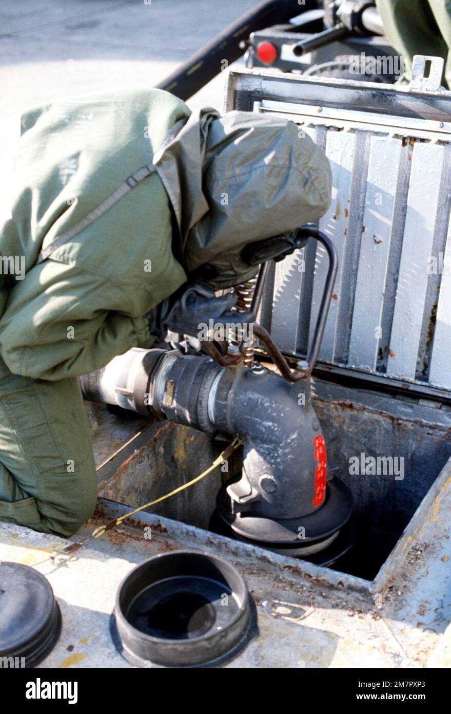 A member of the 436th Military Airlift Wing, wearing chemical warfare ...