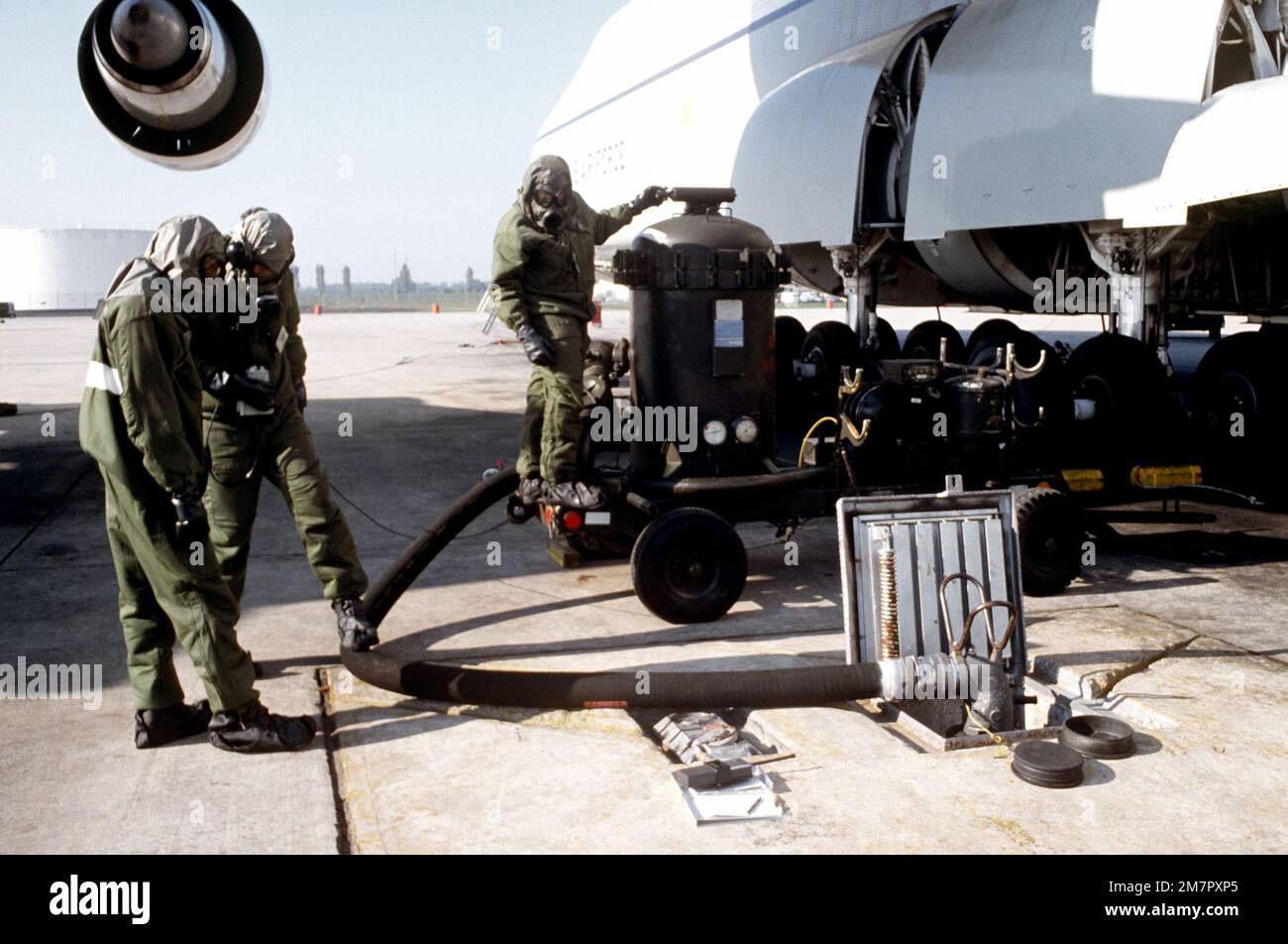 Members of the 436th Military Airlift Wing, dressed in chemical warfare ...