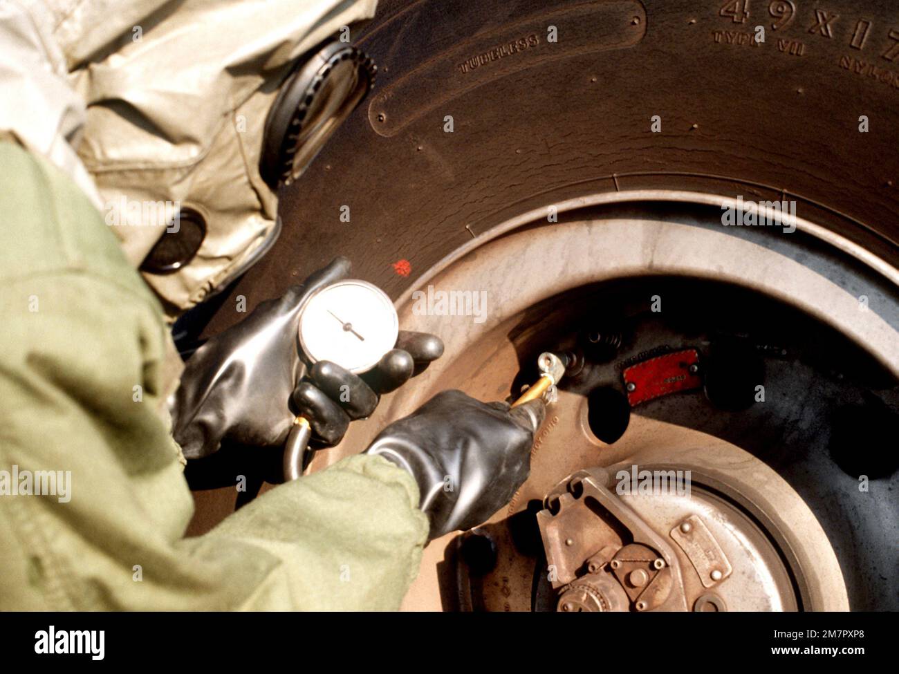 A crew member of the 436th Military Airlift Wing, dressed in chemical ...
