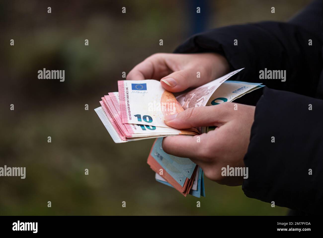 Selective focus on detail of EURO banknotes. Counting or giving EURO ...