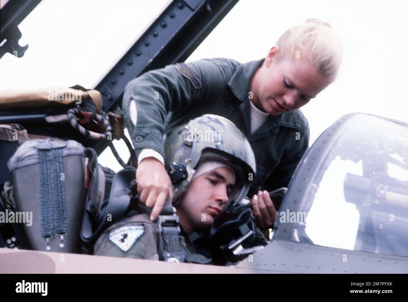 An airman assists a pilot aboard an F-4E Phantom II aircraft during ...