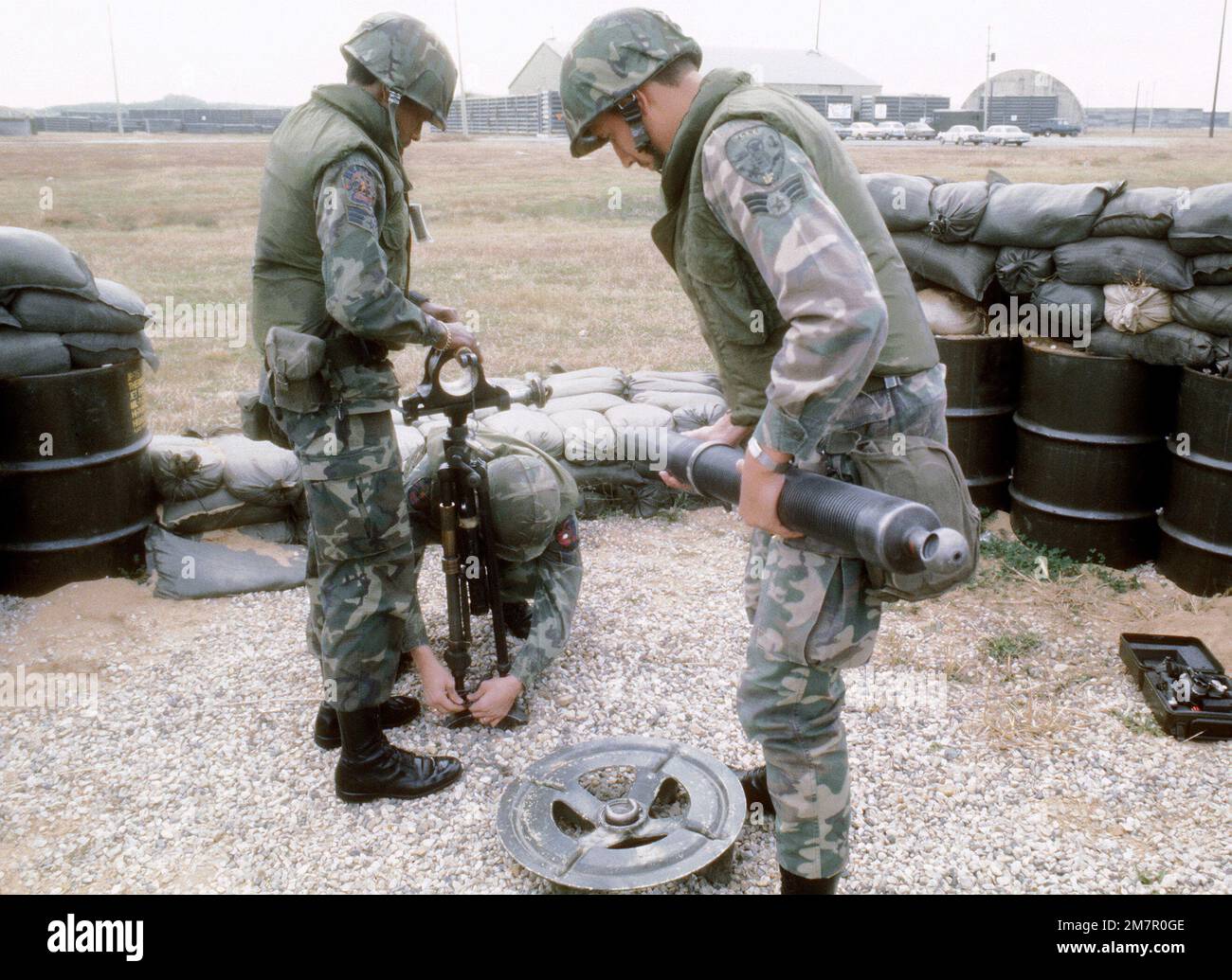 Three sergeants assemble an M-29 81mm mortar. Base: Osan Air Base ...