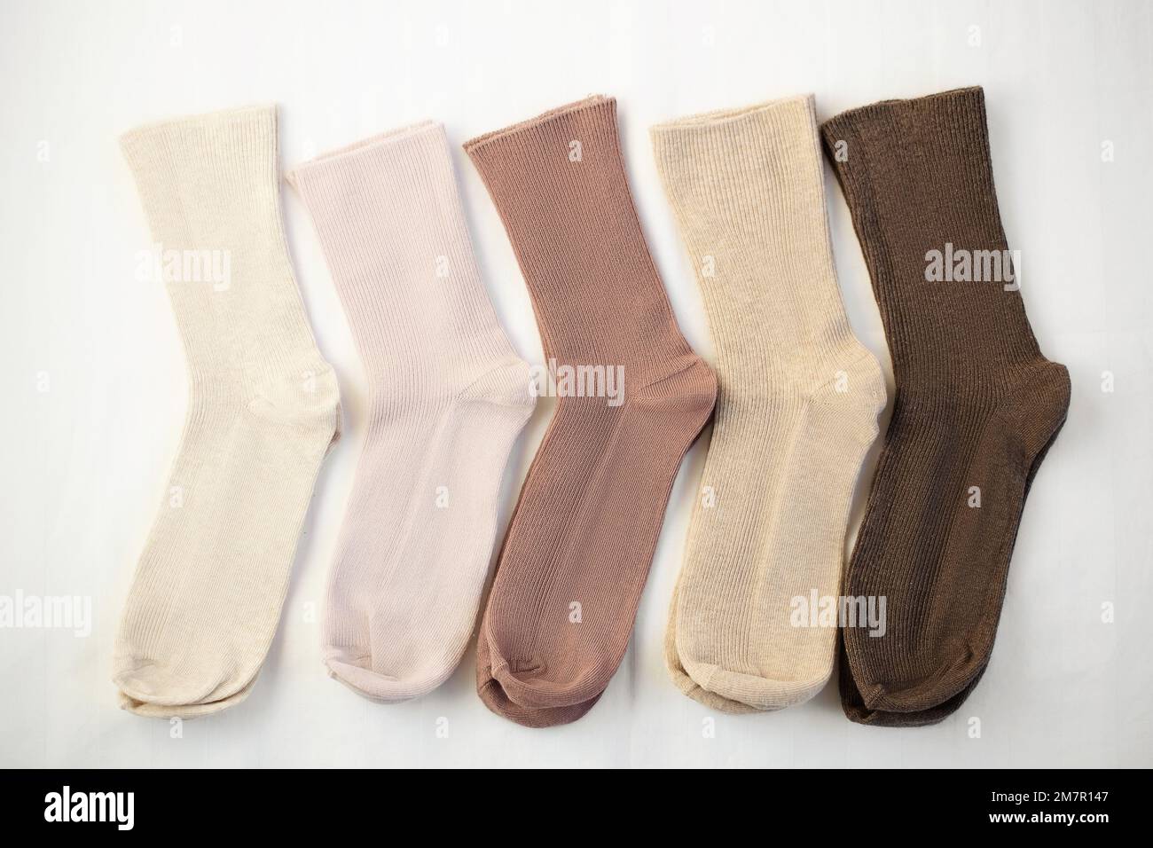A set of womans socks denim pastel colors laying on white sheets Stock ...