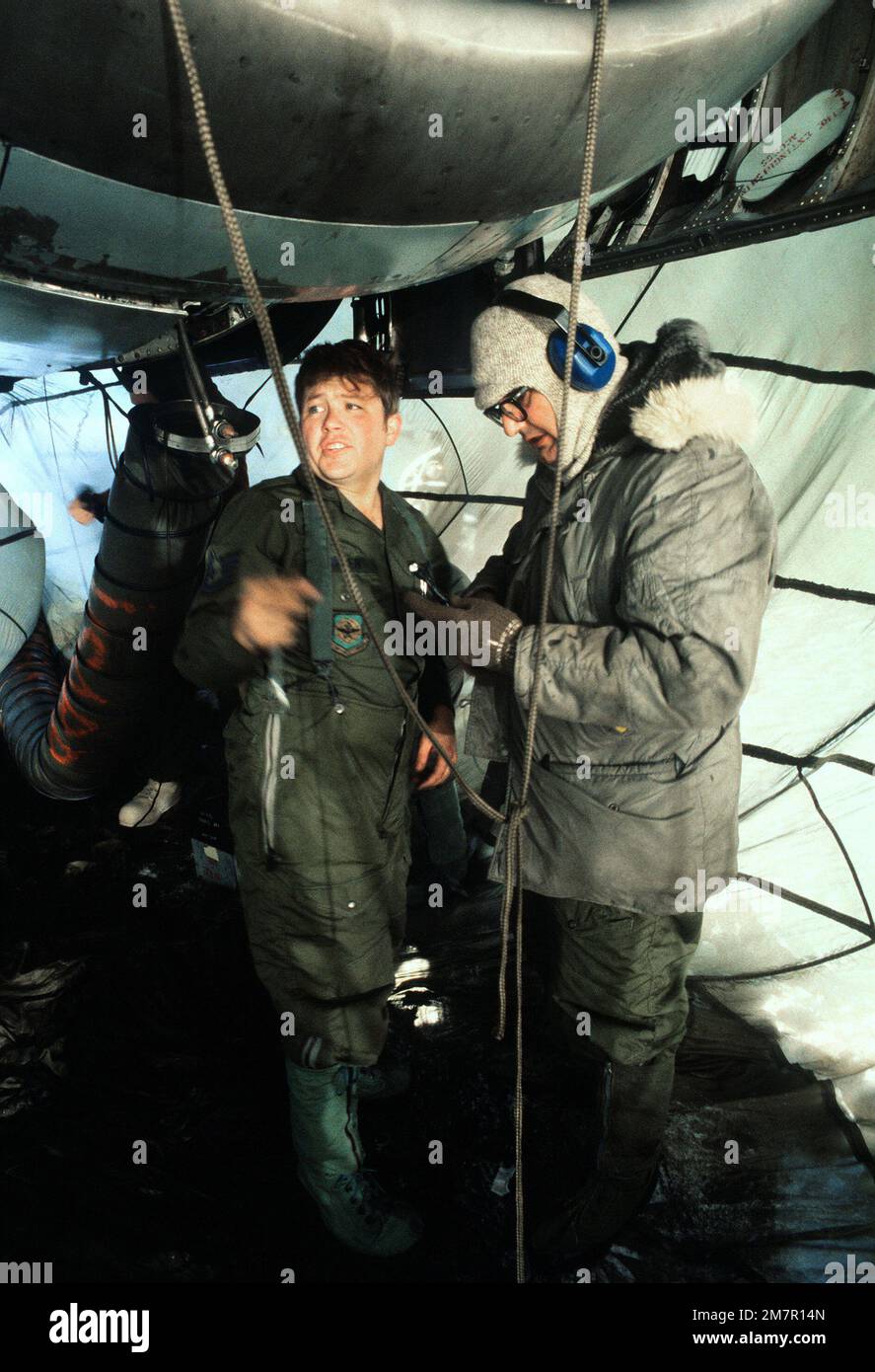 Members of the 619th Military Airlift Support Squadron (MASS) work on ...