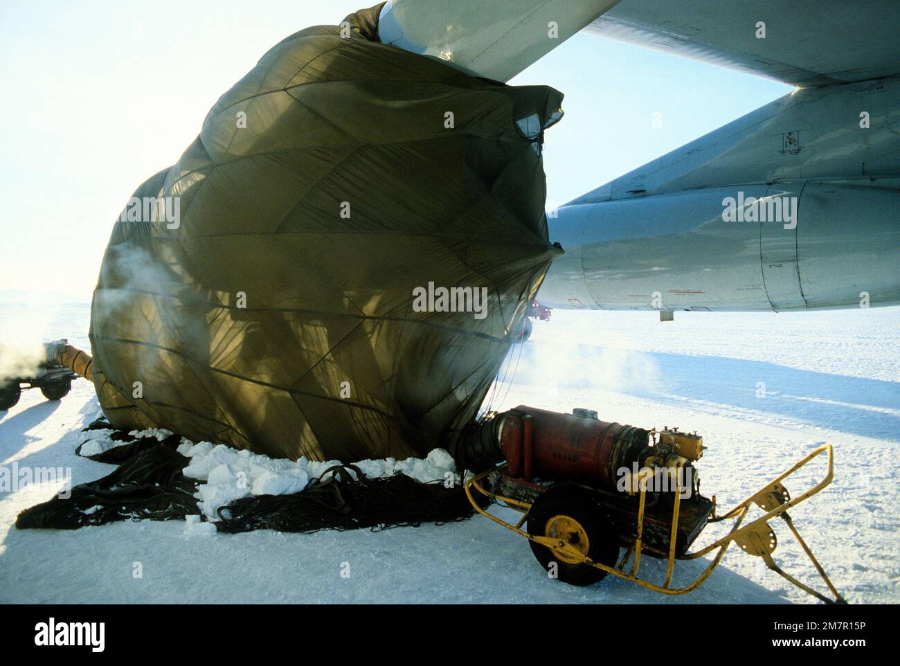 A heating system is attached to a makeshift shelter, around C-141 ...