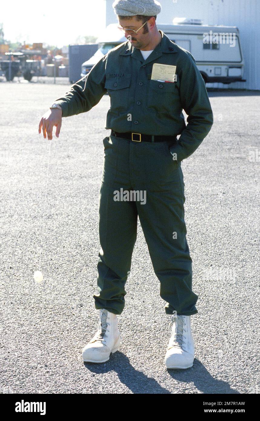 Navy CHIEF Frank Pedraza waits to board a C-141 Starlifter aircraft for ...