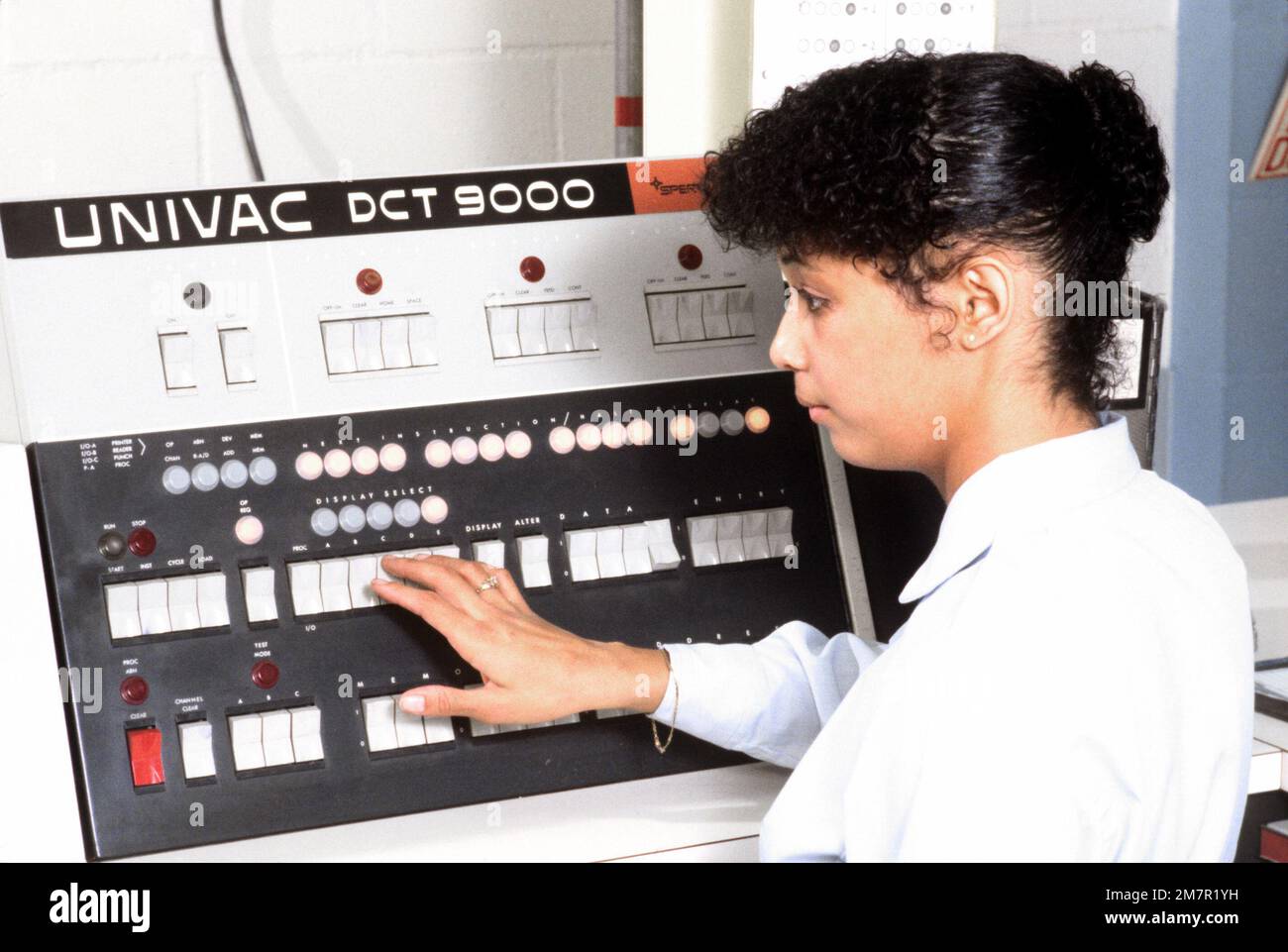 An operator works with a Univac DCT 9000 message receiver and printer ...
