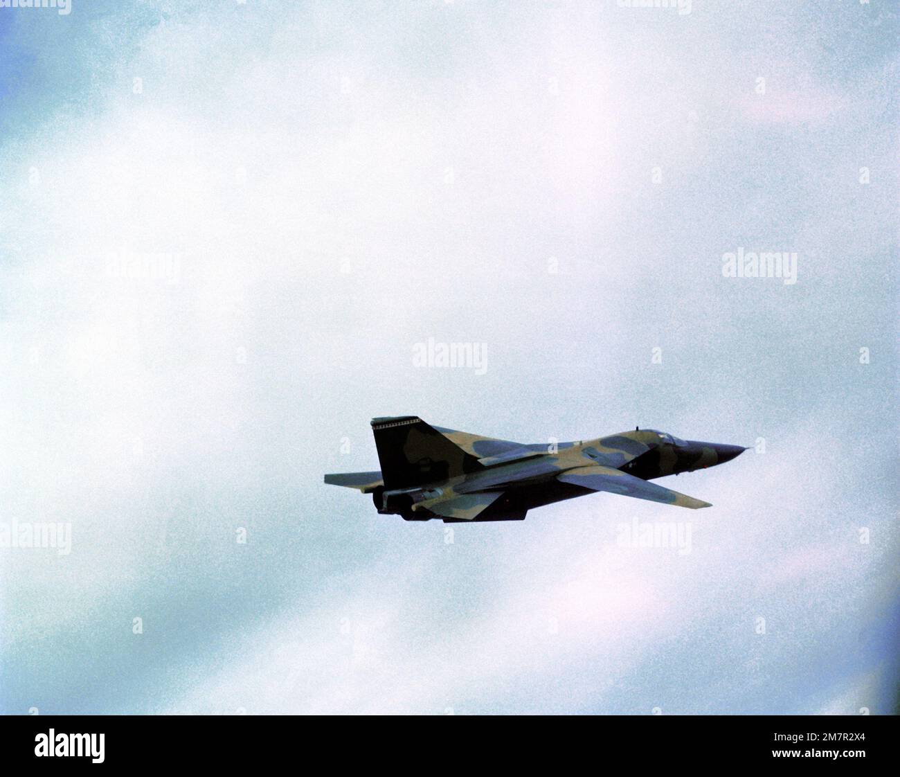 An air-to-air right rear view of an F-111 aircraft during testing of B ...