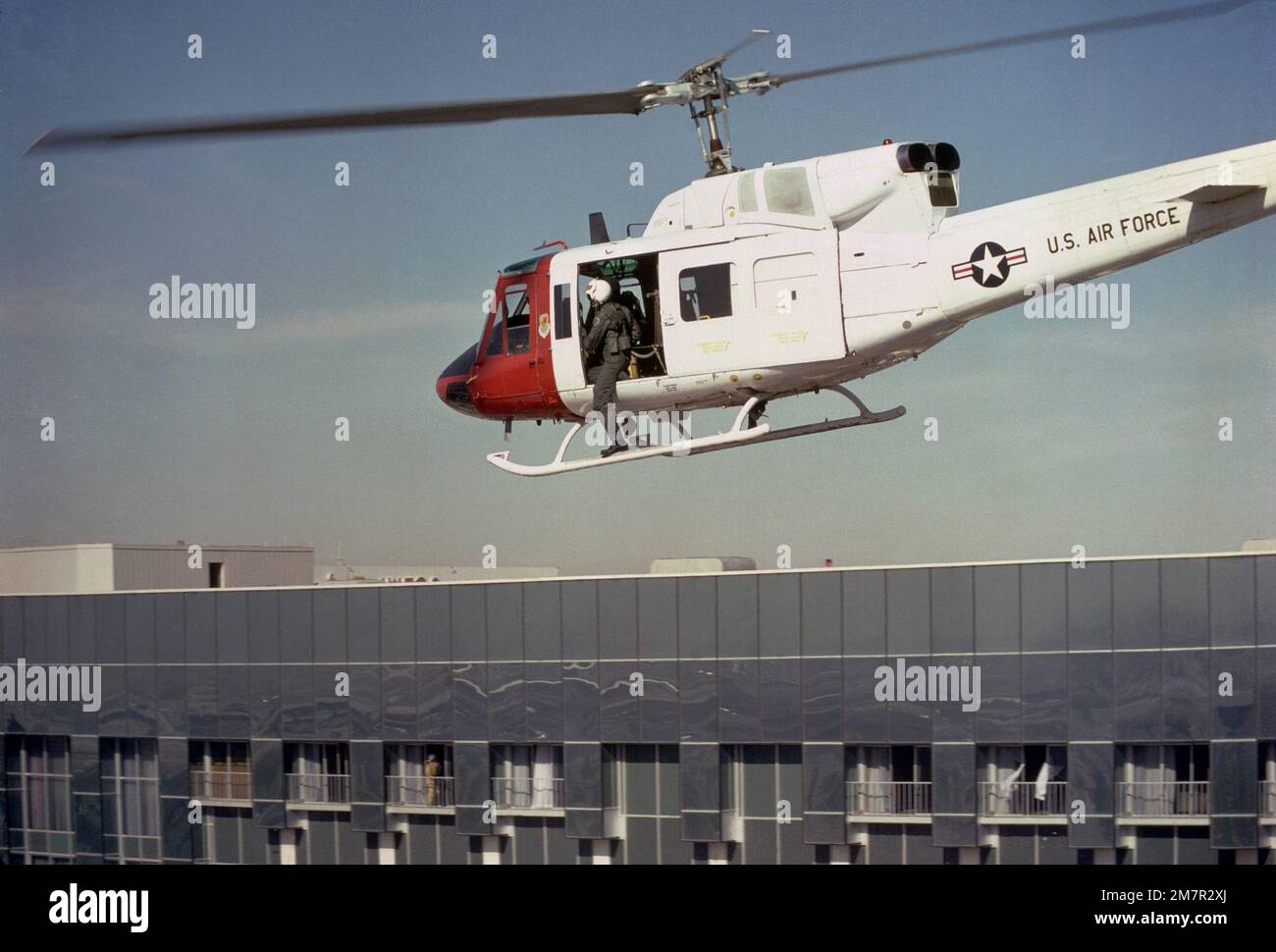A UH-1N Iroquois helicopter comes in for a landing on the roof of the ...