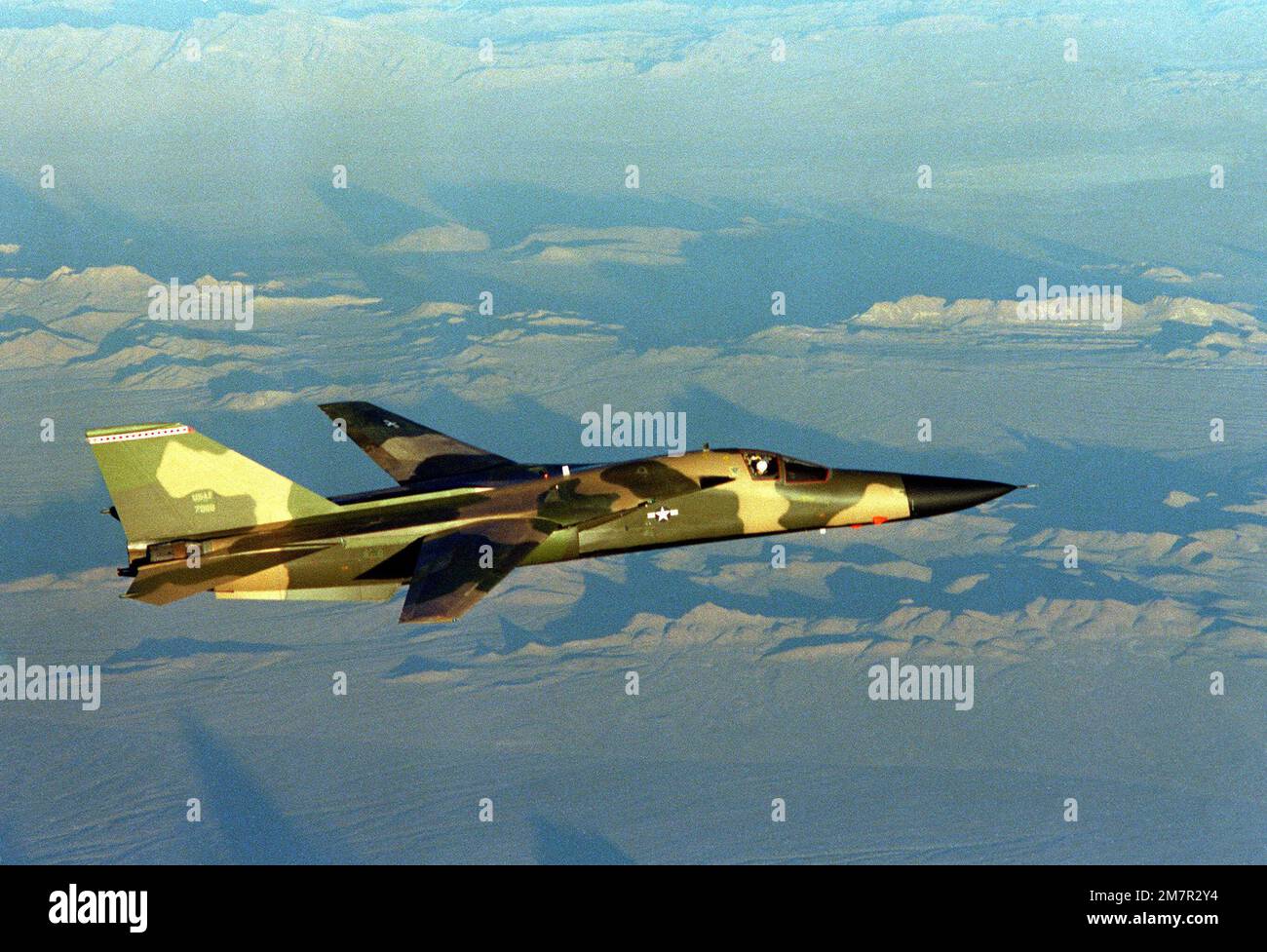 An air-to-air right side view of an F-111 aircraft during testing of B ...