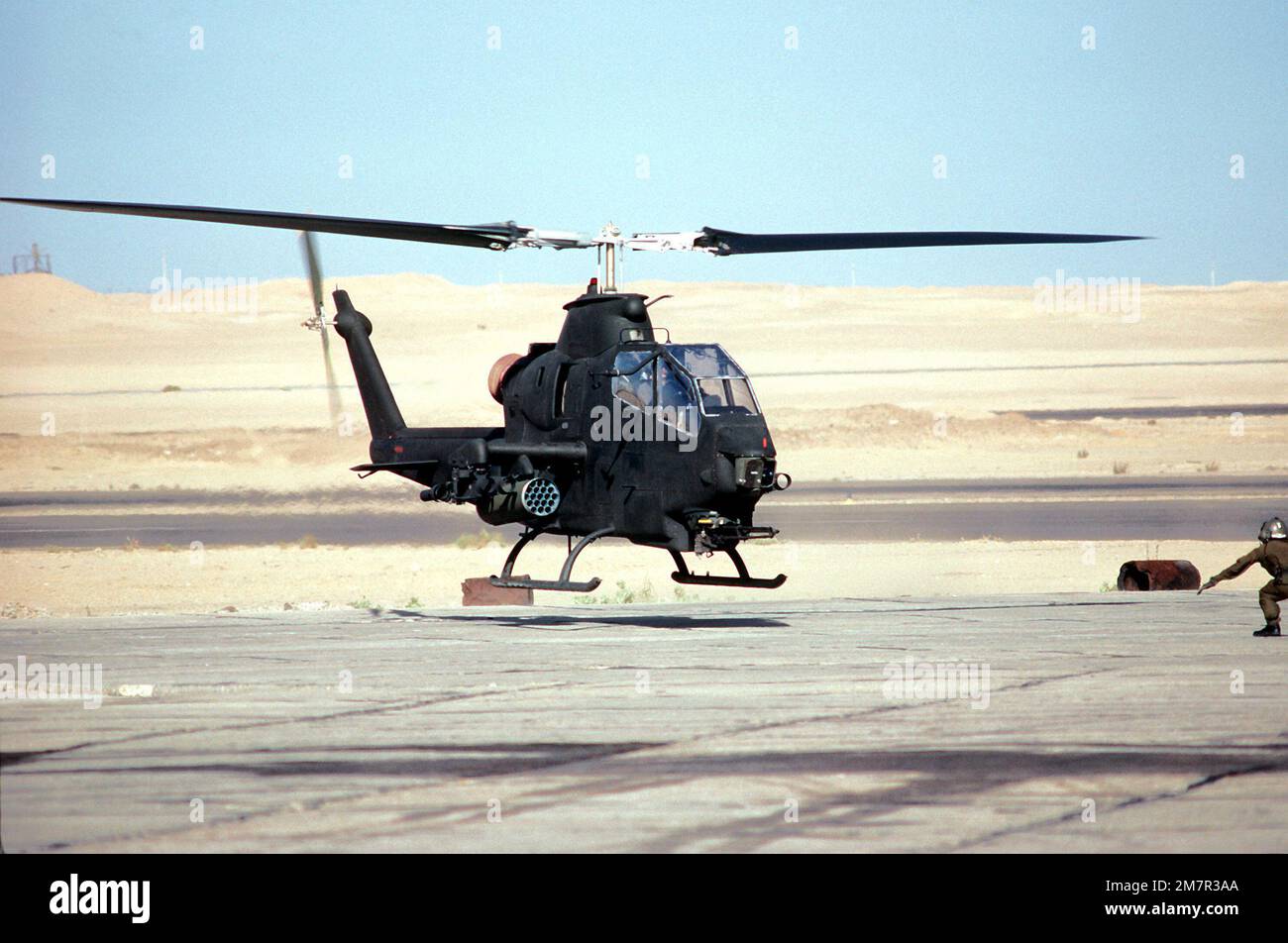 A left front view of an AH-1 Cobra helicopter landing after a mission during exercise Bright ...