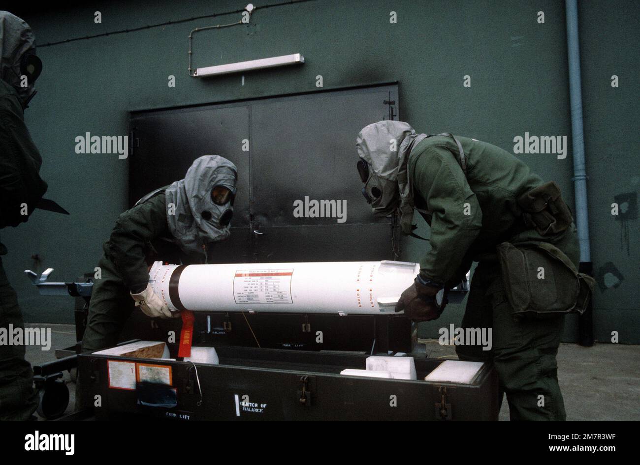 Members of the 50th Munitions Maintenance Squadron uncrate an AIM-7 ...