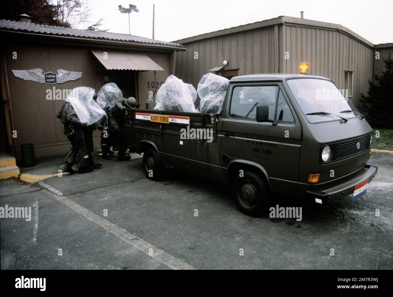 Members of the 50th Tactical Fighter Wing dressed in chemical warfare ...