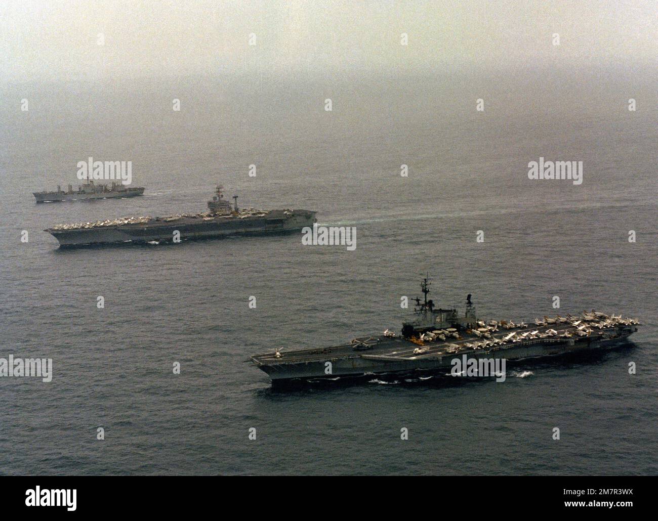 An aerial port view of the aircraft carrier USS MIDWAY (CV 41), right ...