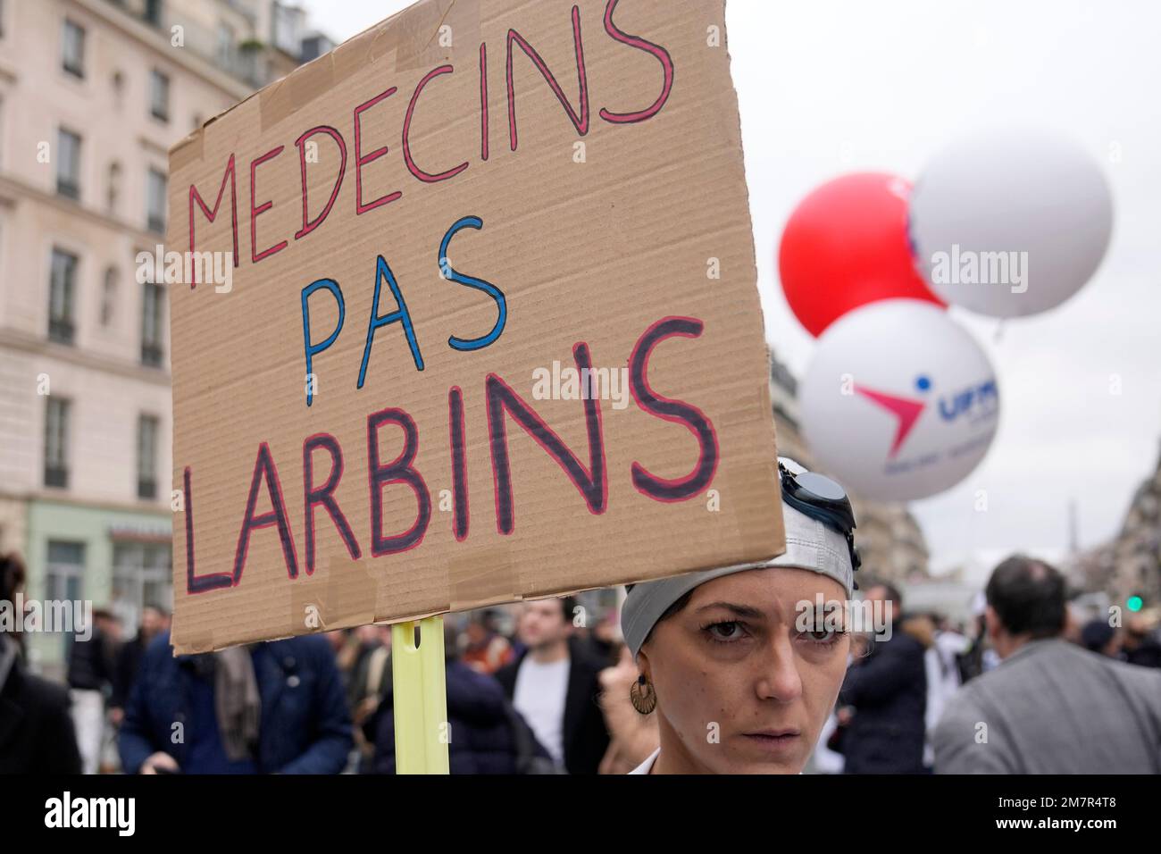 Doctors protest, with a banner reading "Doctors not Lackeys", amid an ...