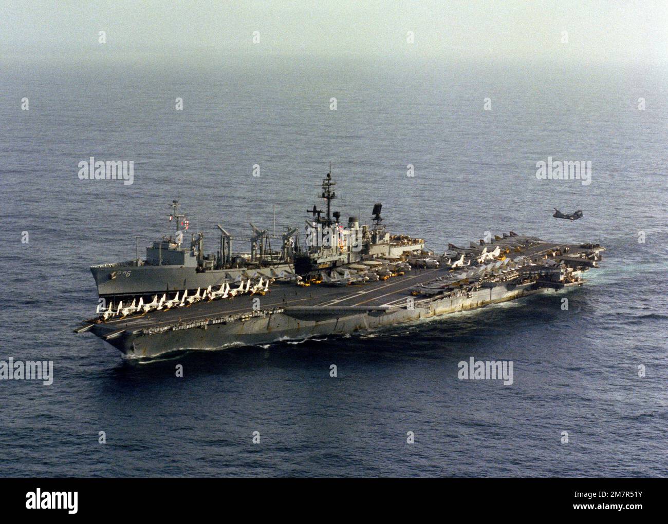 An aerial port view of the aircraft carrier USS MIDWAY (CV 41) and the ...