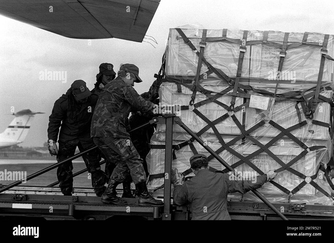 A pallet of US Army tents is offloaded from an Air Force C-130 Hercules ...